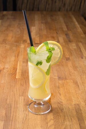 Yellow drink on wooden background. For fast food restaurant design or ...