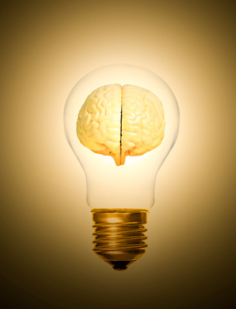 concept of brain within a light bulb lit up moment as a light bulb ...