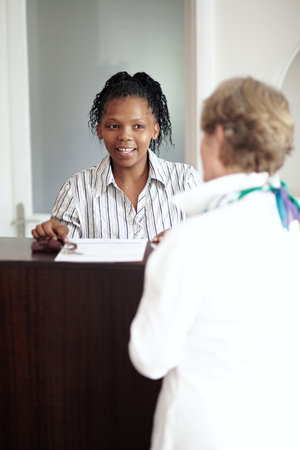 Checking in. a senior woman checking in at the hotel. - Stock Image ...