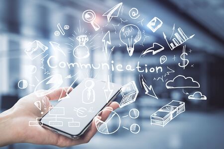 Hand holding smartphone with drawing global communication plan on ...