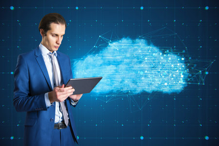 Attractive young european businessman using tablet with digital glowing ...