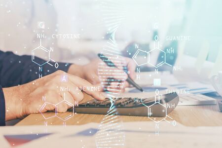 Mans hands working with notes background. Genetic engineering and gene ...