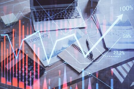 Financial graph colorful drawing and table with computer on background ...