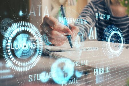 Double exposure of hands making notes with digital coding icons ...