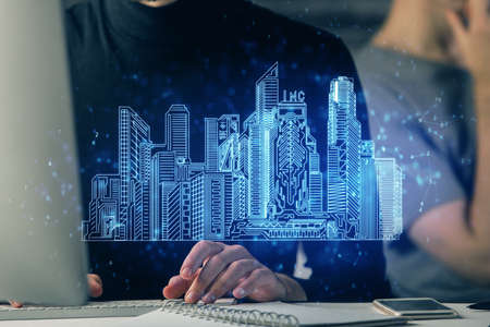 High tech city drawing with businessman working on computer on ...