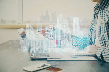 High tech city drawing with businessman working on computer on ...