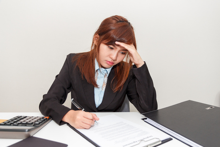 Stressed businesswoman in black suit thinking about work on her desk ...