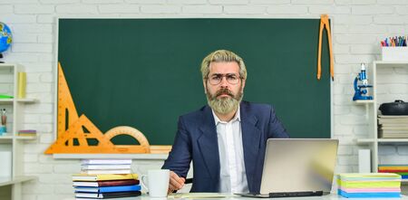 Selecting specific courses. School teacher programming laptop. Learn ...