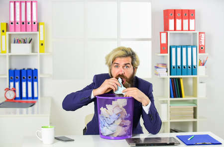 Rummaging through the papers. Businessman hold trash can. Man look for ...