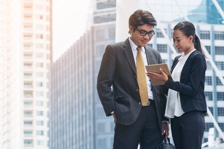 Businessman and businesswoman discussion on business issue on tablet ...