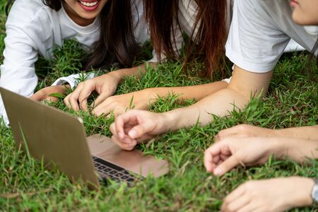 Team of young students studying in a group project in the park of ...