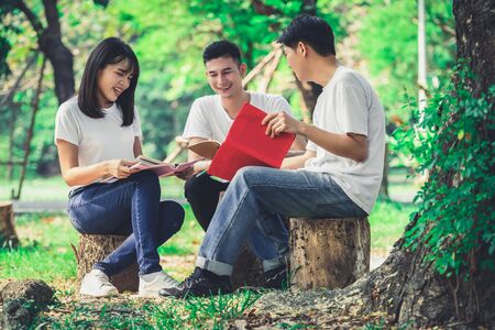 Team of young students studying in a group project in the park of ...