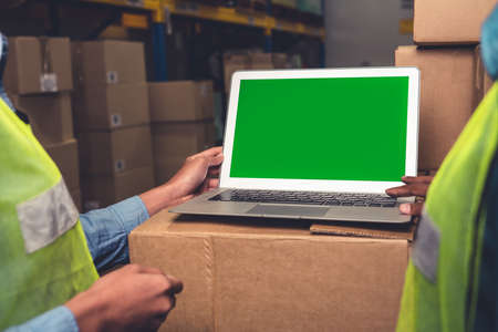 Computer with green screen display in warehouse storage room . Delivery ...
