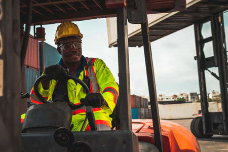 African american man driving forklift in shipyard . Logistics supply ...