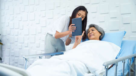 Elderly female patient and her daughter video calling update your ...