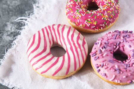 Baked sweet delicious donuts with pastry crumb on gray concrete ...