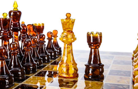 Natural amber different chess pieces figures standing on brown stone ...