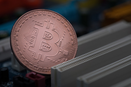 Bitcoin digital currency, bit-coin on motherboard or electronic board ...