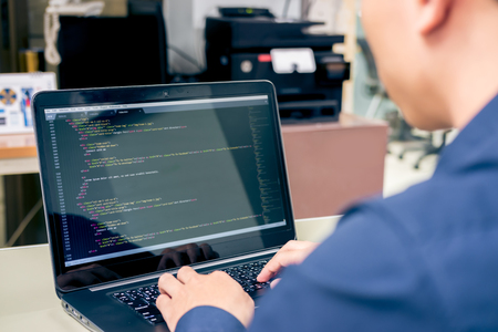 Developing programming and coding technologies on desk white blurry ...