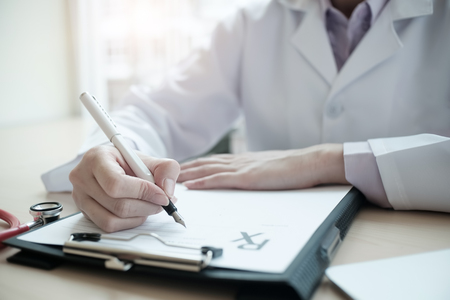 Medicine doctor hand writing something on medical from. Medical care ...