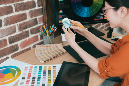 high angle view photo of young pretty designer woman using mobile ...