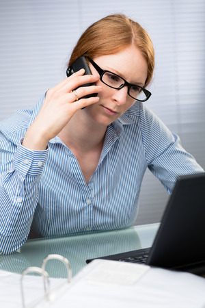 A busy manager or business assistant behind a computer on an office ...