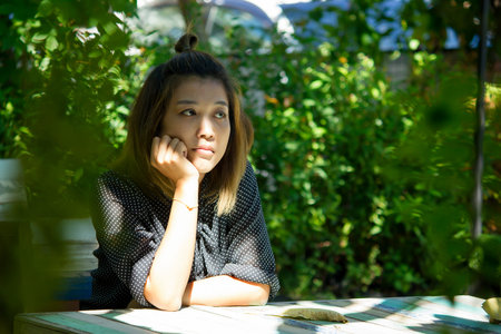 Female support the chin on the table. - Stock Image - Everypixel