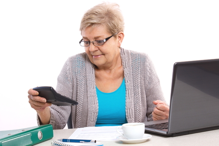 Worried senior woman, an elderly pensioner counting utility bills at ...