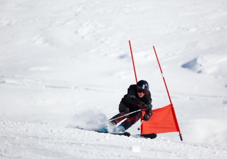 Young skier doing downhill on Giant Slalom course; horizontal ...
