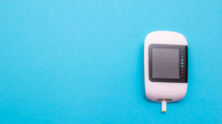 glucometer on a blue background. electronic diagnostic device - Stock ...
