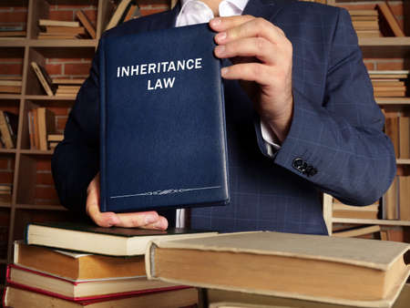 INHERITANCE LAW book in the hands of a lawyer. Inheritance law governs ...