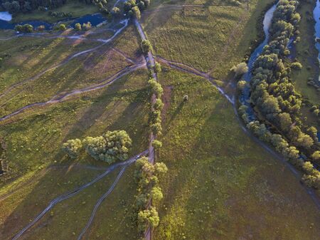 Aerial view of grassland, trees and shrubs with a network of small ...