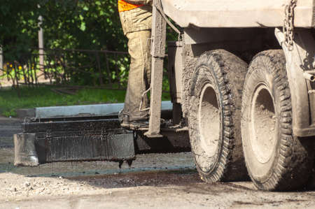 the process of preparing for the laying of new asphalt. machine pouring ...
