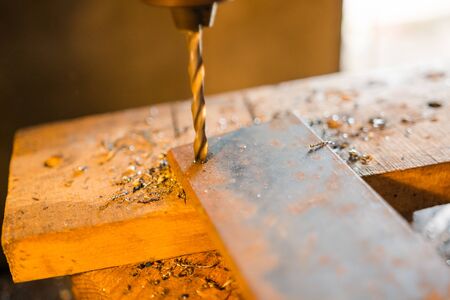 drill board. man drills board. use a construction tool. Building ...