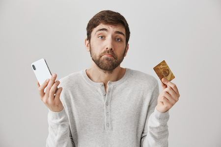 Guy refuses to go out, having no money on bank account. Portrait of sad ...