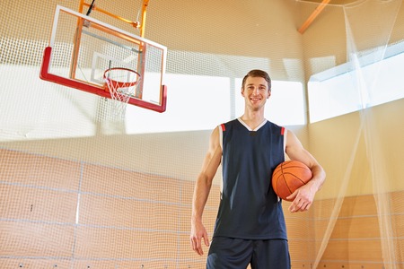 Portrait of happy handsome tall basketball player on court - Stock ...
