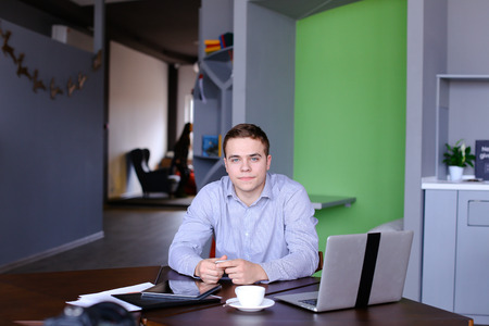 Handsome and self-assured guy, manager of company pondered and stares ...