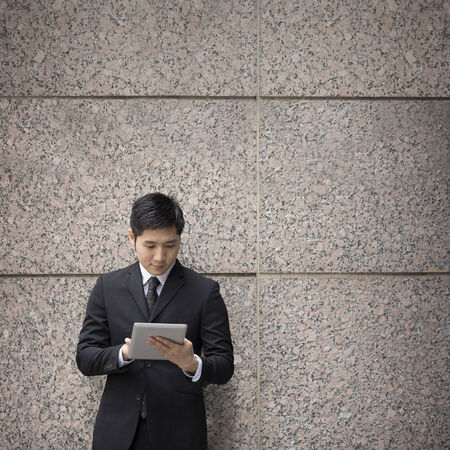 Chinese man with a tablet computer. Asian business man using digital ...