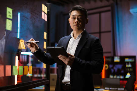 Confident male ceo manager, writing tasks or new startup ideas on ...