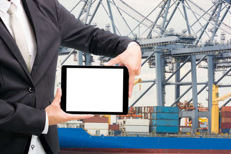 Engineering working hold tablet in front of cargo loading workplace ...