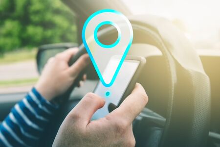 Female driving car and using gps navigation app on smartphone to find ...