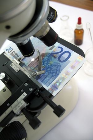 Checking for fake euro banknote using a microscope - Stock Image ...