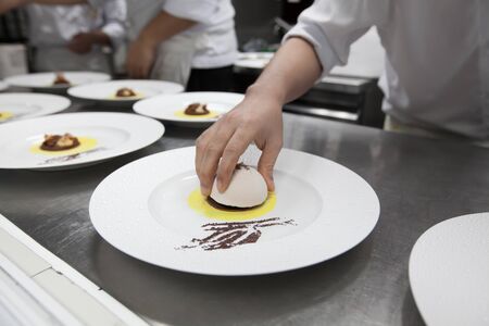 The chef prepares desserts with ice-cream for dinner party in ...