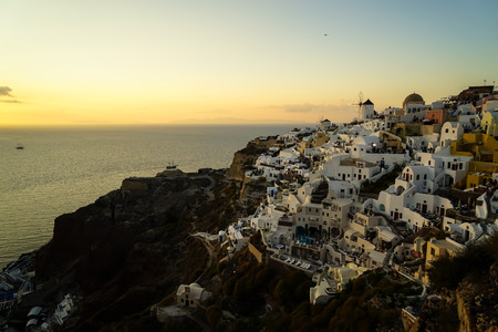 Panoramic skyline scene in sunset light of Oia windmill and white ...