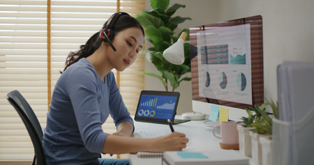 Asia people young casual woman remote work at desk home phone call talk ...