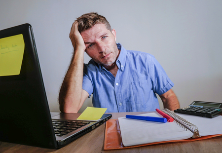 young crazy stressed and overwhelmed man working messy at office desk ...