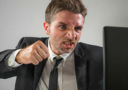upset and angry businessman at computer desk in office- unhappy man ...