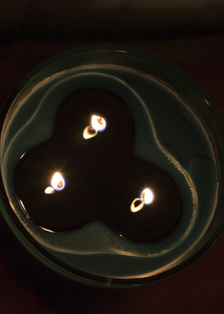Single green candle with three short wicks burning - Stock Image ...