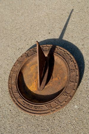 An old steel nautical sundial in the shape of a sailboat, with a ...