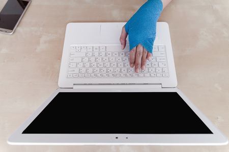 work injury. injured woman hand sore with blue elastic bandage on hand ...